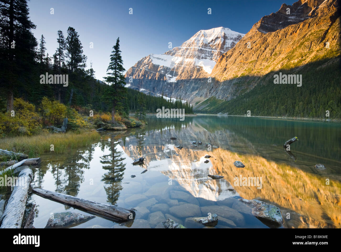 Mount Edith Cavell reflected in Cavell Lake in Jasper National Park ...