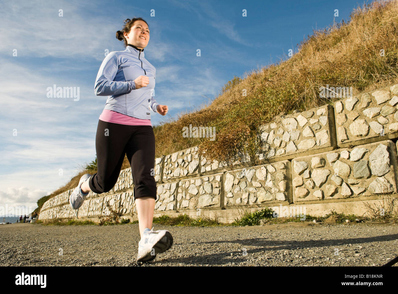 A woman running along the Dallas Road Waterfront, Victoria, British ...