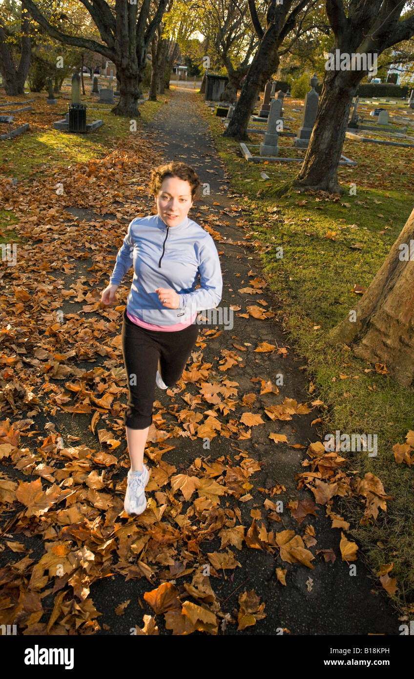 A female runner at the Ross Bay Cemetery in Victoria, British Columbia ...