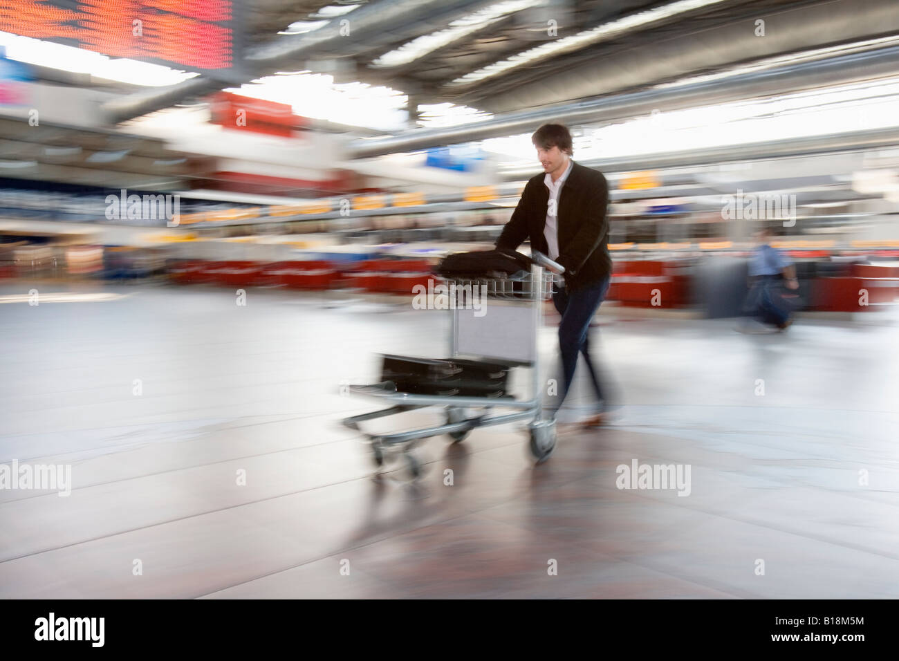 YOUNG MAN HURRYING AT THE AIRPORT Stock Photo - Alamy
