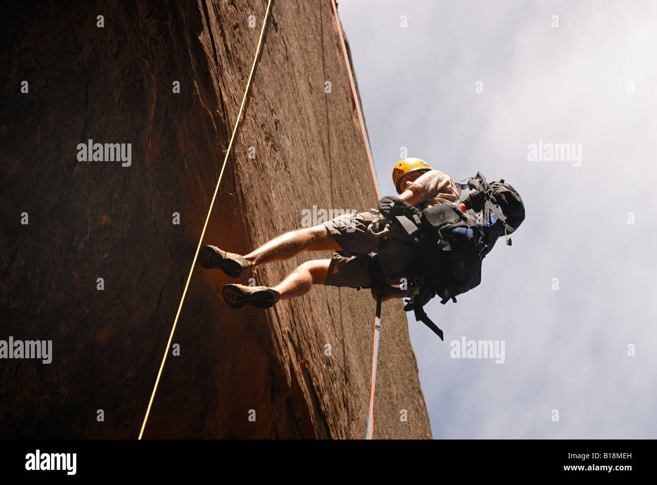 Tourist hanging on a rope while Canyoning in the area of the slick rock ...
