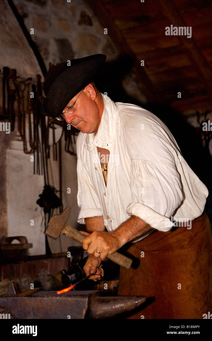 Blacksmith working in the forge at the Fortress of Louisbourg ...