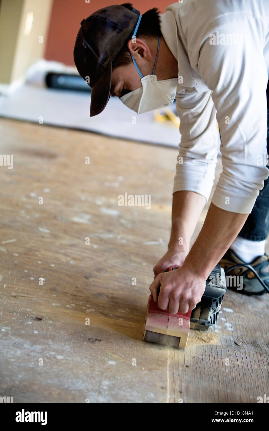 Man sanding a floor Stock Photo - Alamy