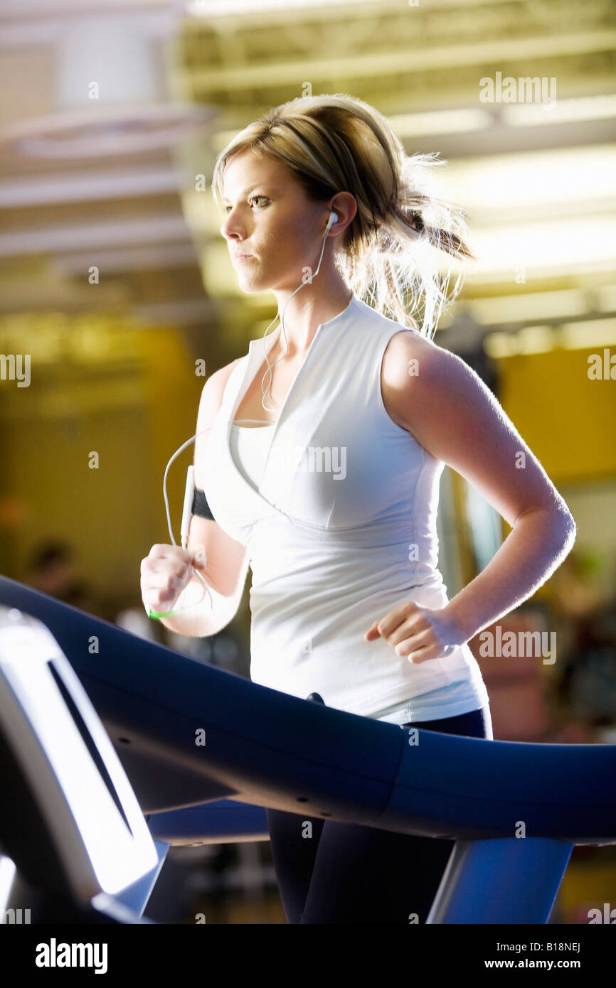 Woman running on a treadmill Stock Photo - Alamy