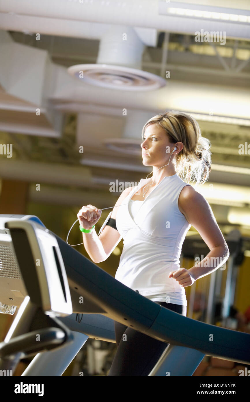 Woman running on a treadmill Stock Photo - Alamy