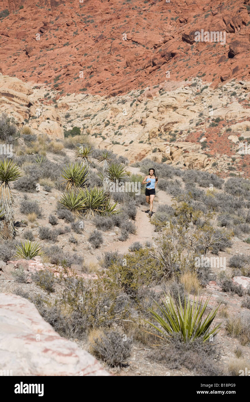 A young female running on a trail by Kraft Mountain, Red Rocks, Las ...