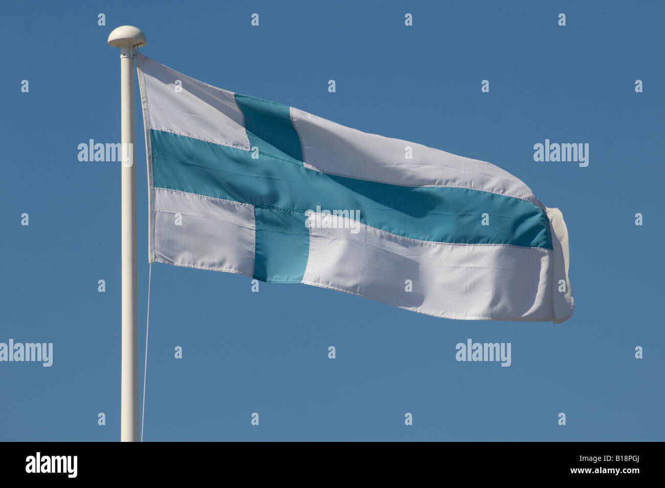Finnish banner flag flying - blue cross on white background, blue sky ...