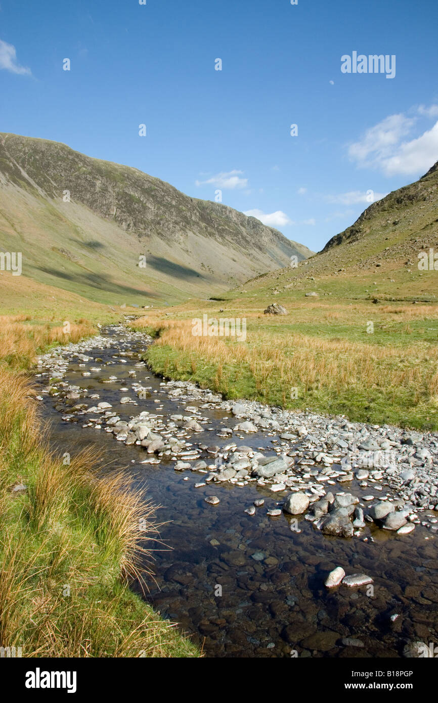 A stream meanders down the steep sided valley at Honister Pass, Lake ...