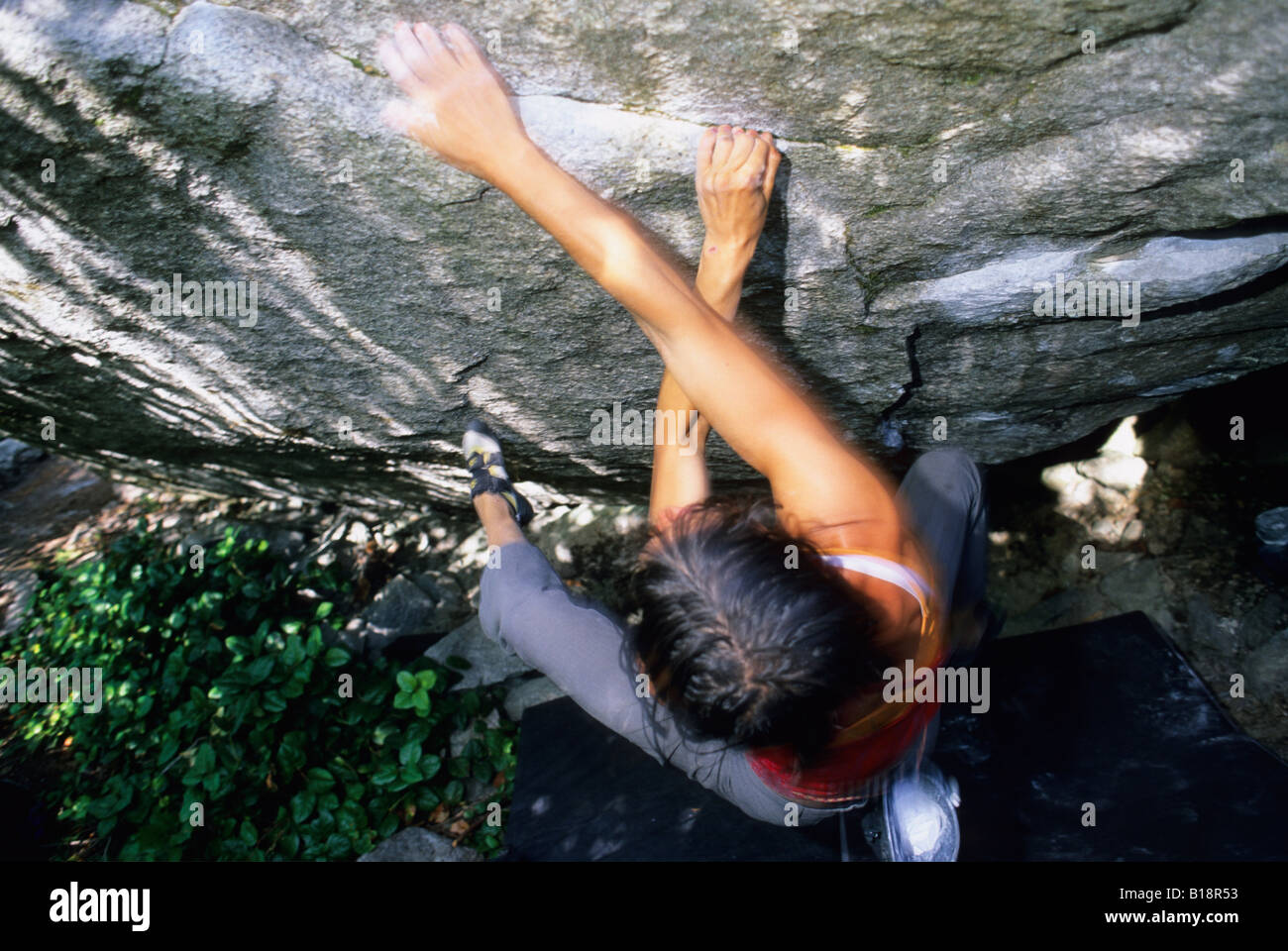 Woman bouldering on Siddhartha, V10, Apron Boulders, Squamish, British ...
