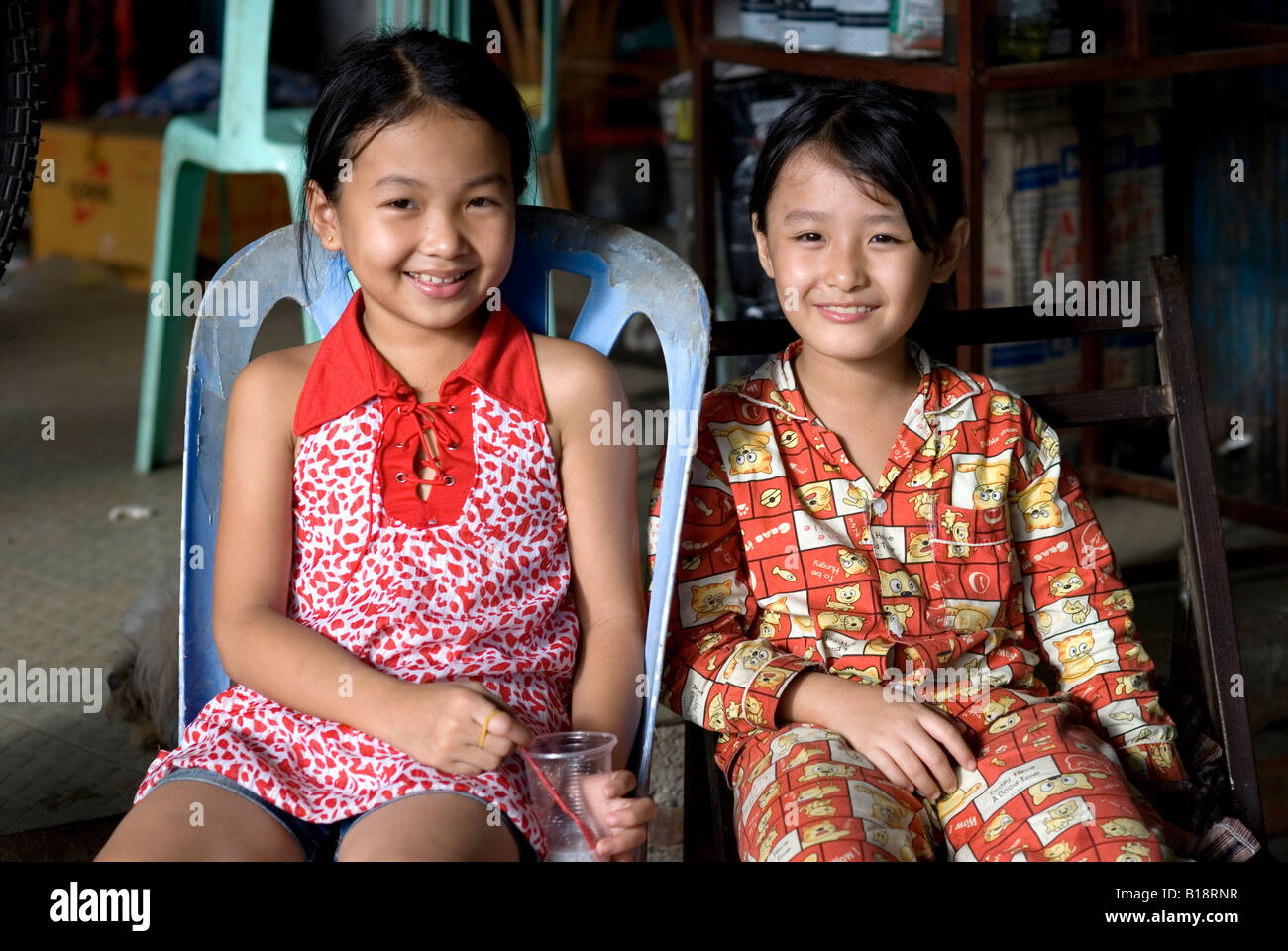 Cambodia Kompong Cham girls in tyre shop Stock Photo - Alamy