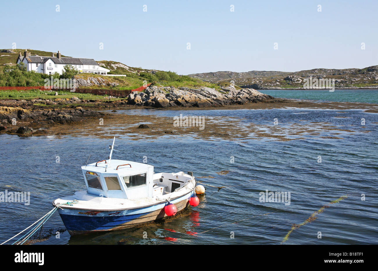 The Coll Hotel and fishing boat on the Isle of Coll Scotland Stock ...