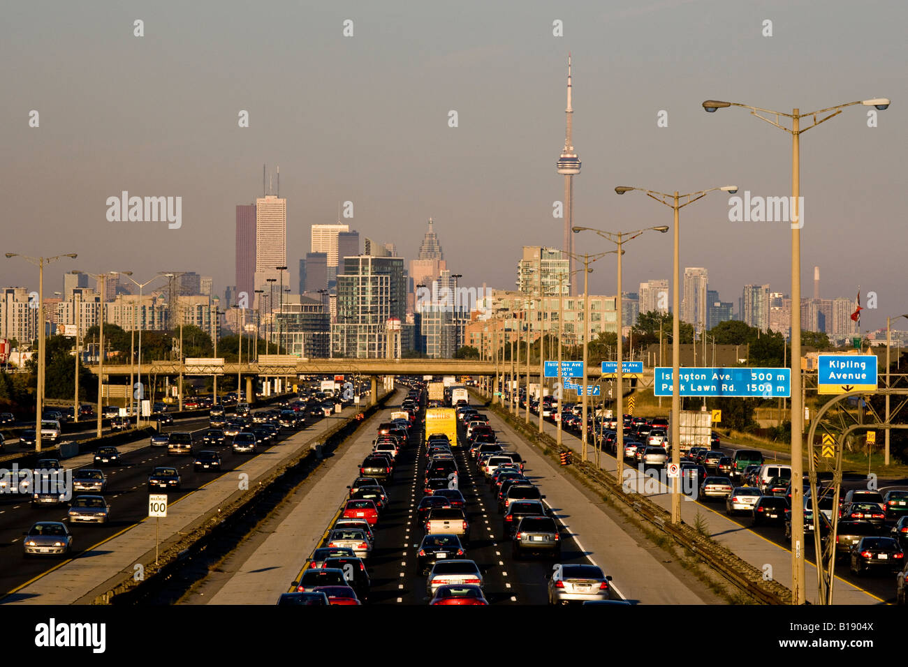 Rush-hour traffic on QEW (Queen Elizabeth Way) and Toronto city skyline ...