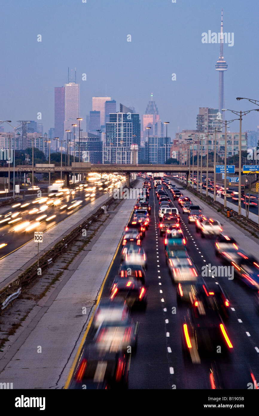 Rush-hour traffic on QEW (Queen Elizabeth Way) and Toronto city skyline ...