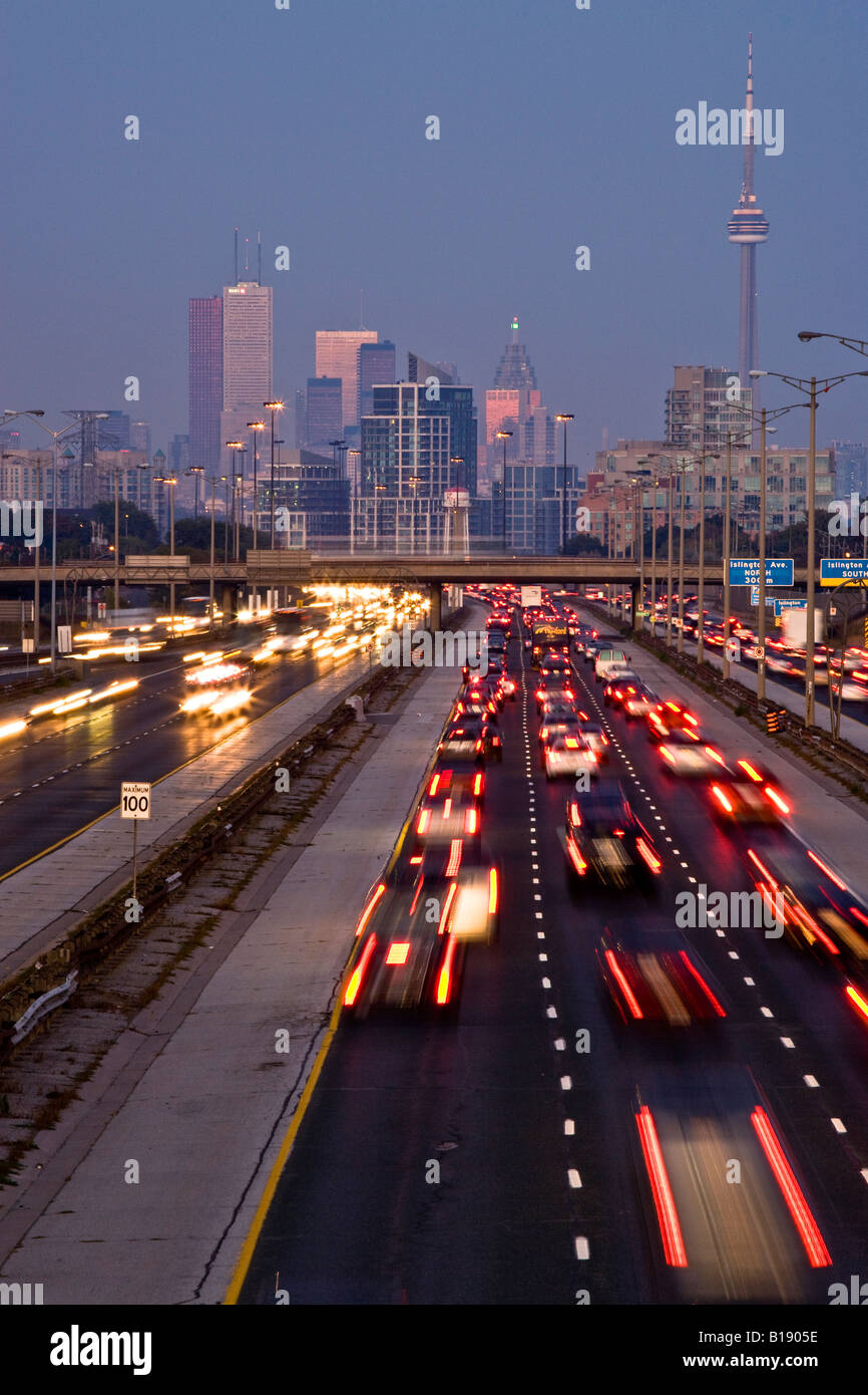 Rush-hour traffic on QEW (Queen Elizabeth Way) and Toronto city skyline ...