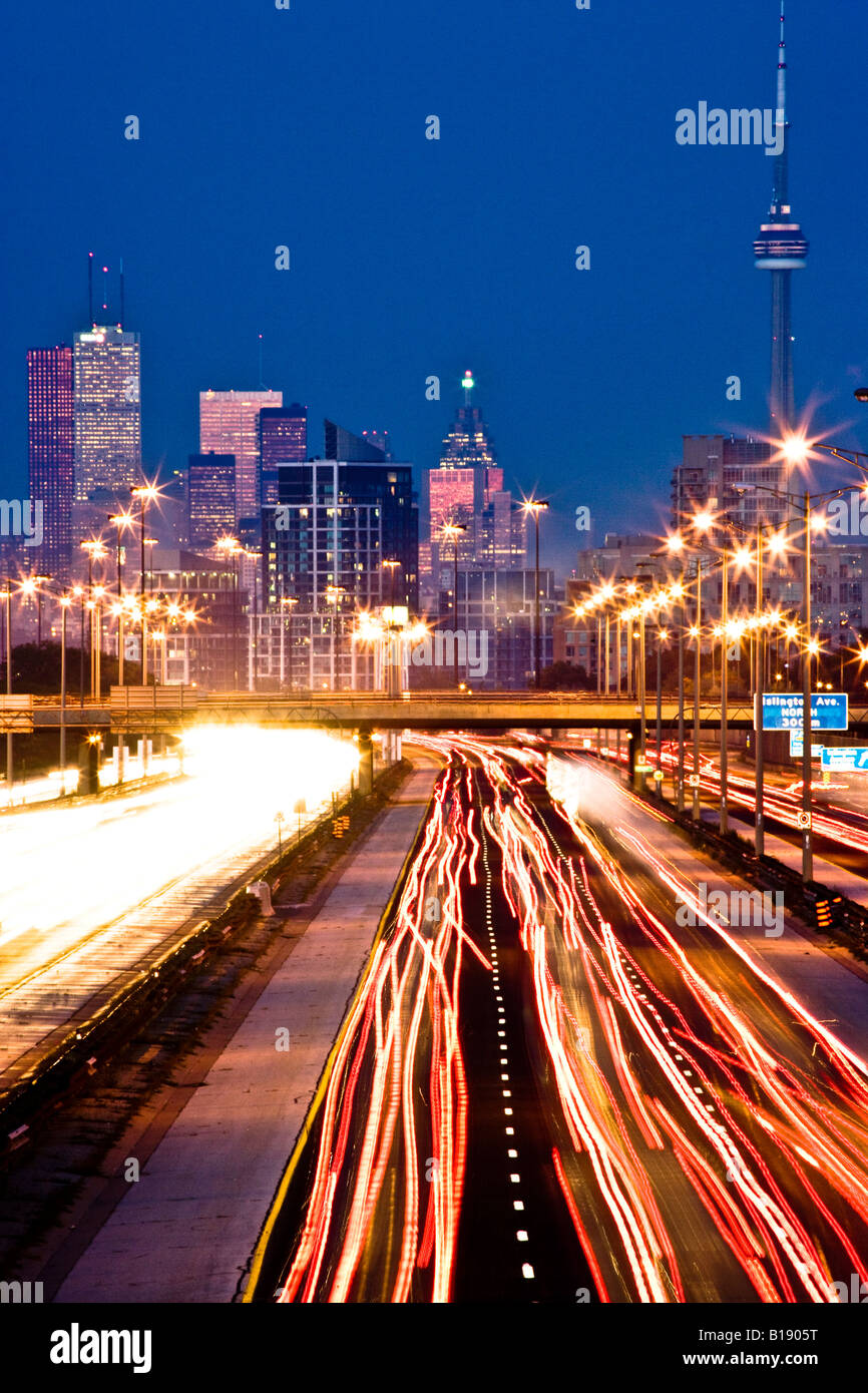 Rush-hour traffic on QEW (Queen Elizabeth Way) and Toronto city skyline ...