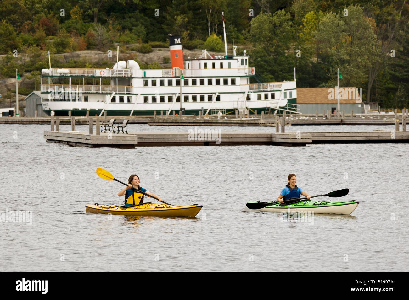 Two young women sea-kayaking on Muskoka Lake, Gravenhurst, Ontario ...