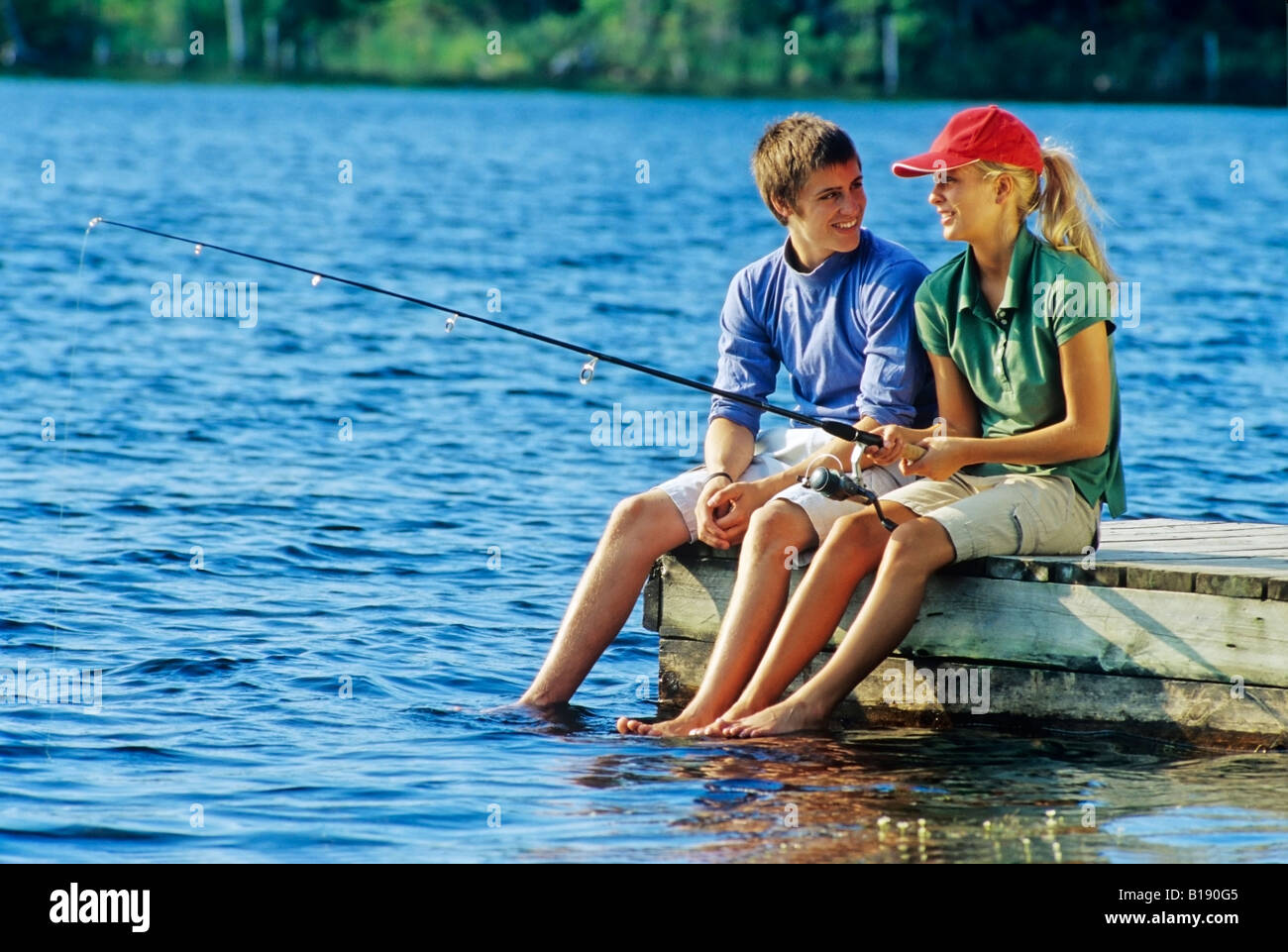 Teenagers on dock, Lyons Lake, Whiteshell Provincial Park, Manitoba ...