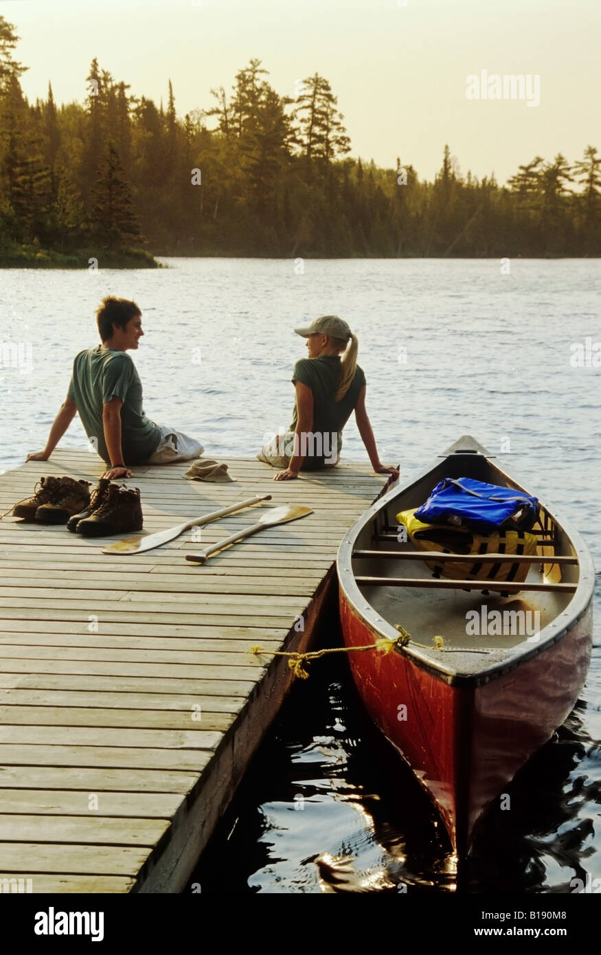 Teens on dock, Lyons lake, Whiteshell Provincial Park, Manitoba, Canada ...