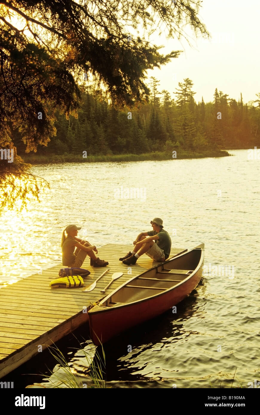 Teens on dock, Lyons Lake, Whiteshell Provincial Park, Manitoba, Canada ...
