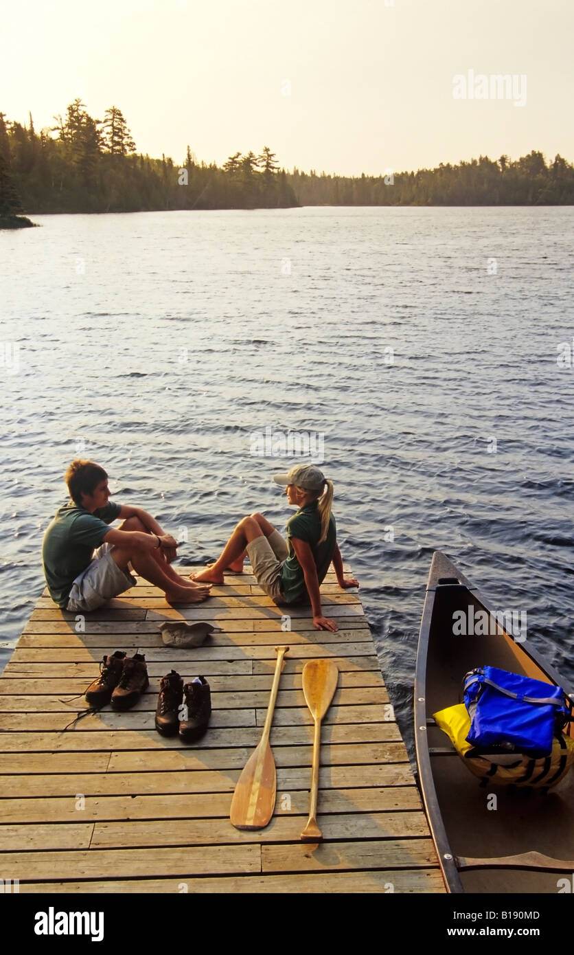 Teens on dock, Lyons Lake, Whiteshell Provincial Park, Manitoba, Canada ...