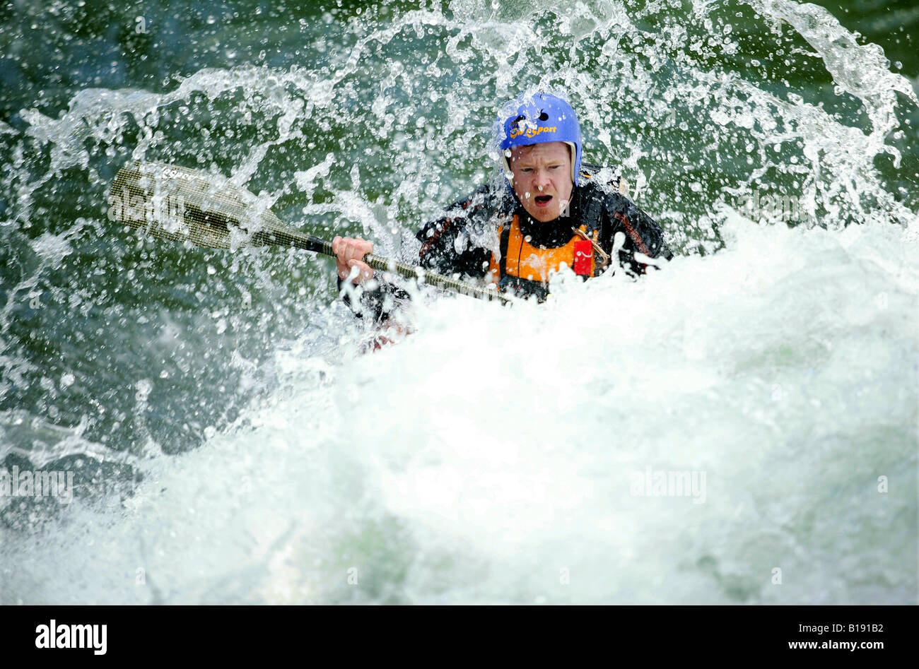 Paddler taking advantage of a large standing wave known as tarp and ...