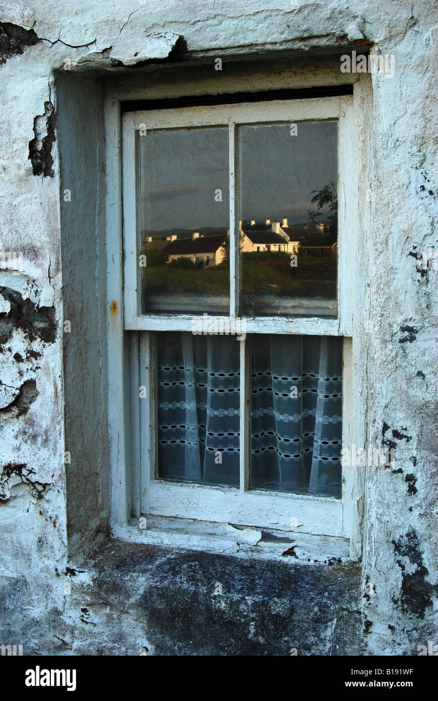 Cottage reflected in the window of another, Easdale, Argyll, Scotland ...