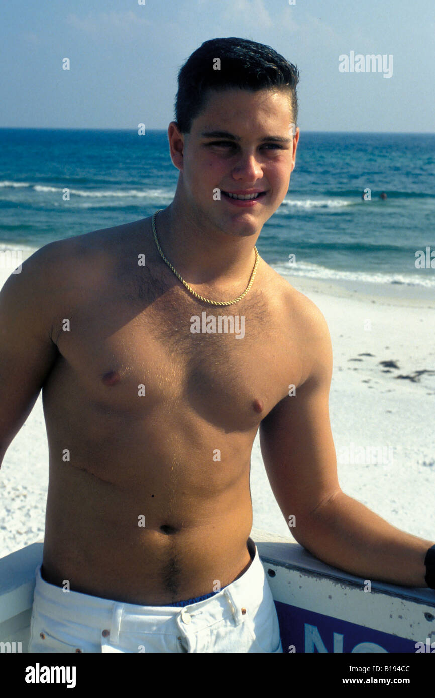 A handsome tanned young man enjoys the Beach at Seaside Florida model ...