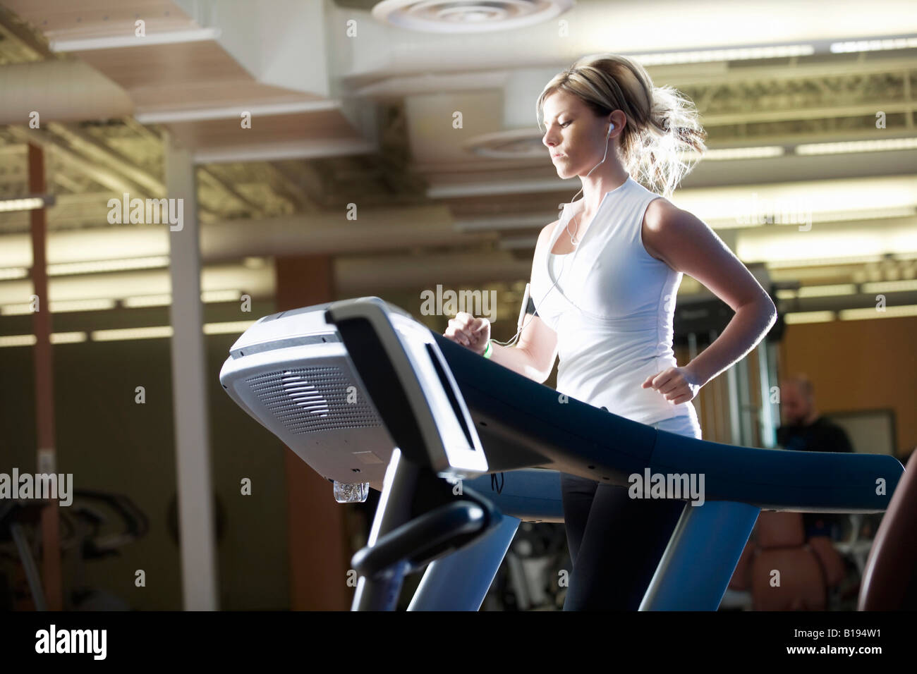 Woman running on treadmill Stock Photo - Alamy