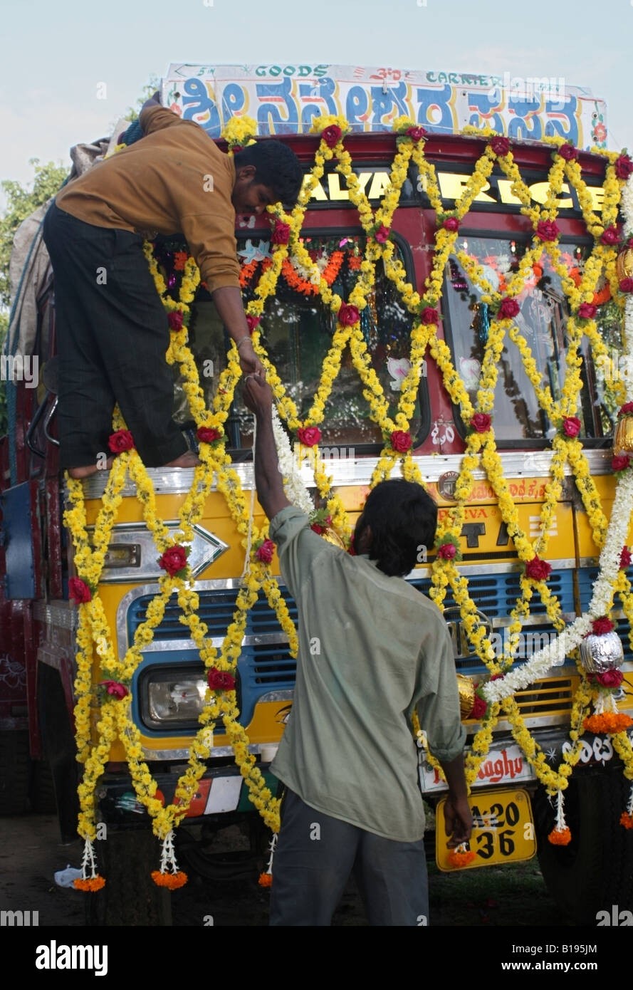 Two truck drivers decorate their truck ready to be blessed during a ...
