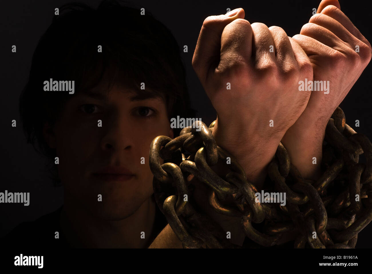 Man with chains on his wrists Stock Photo - Alamy