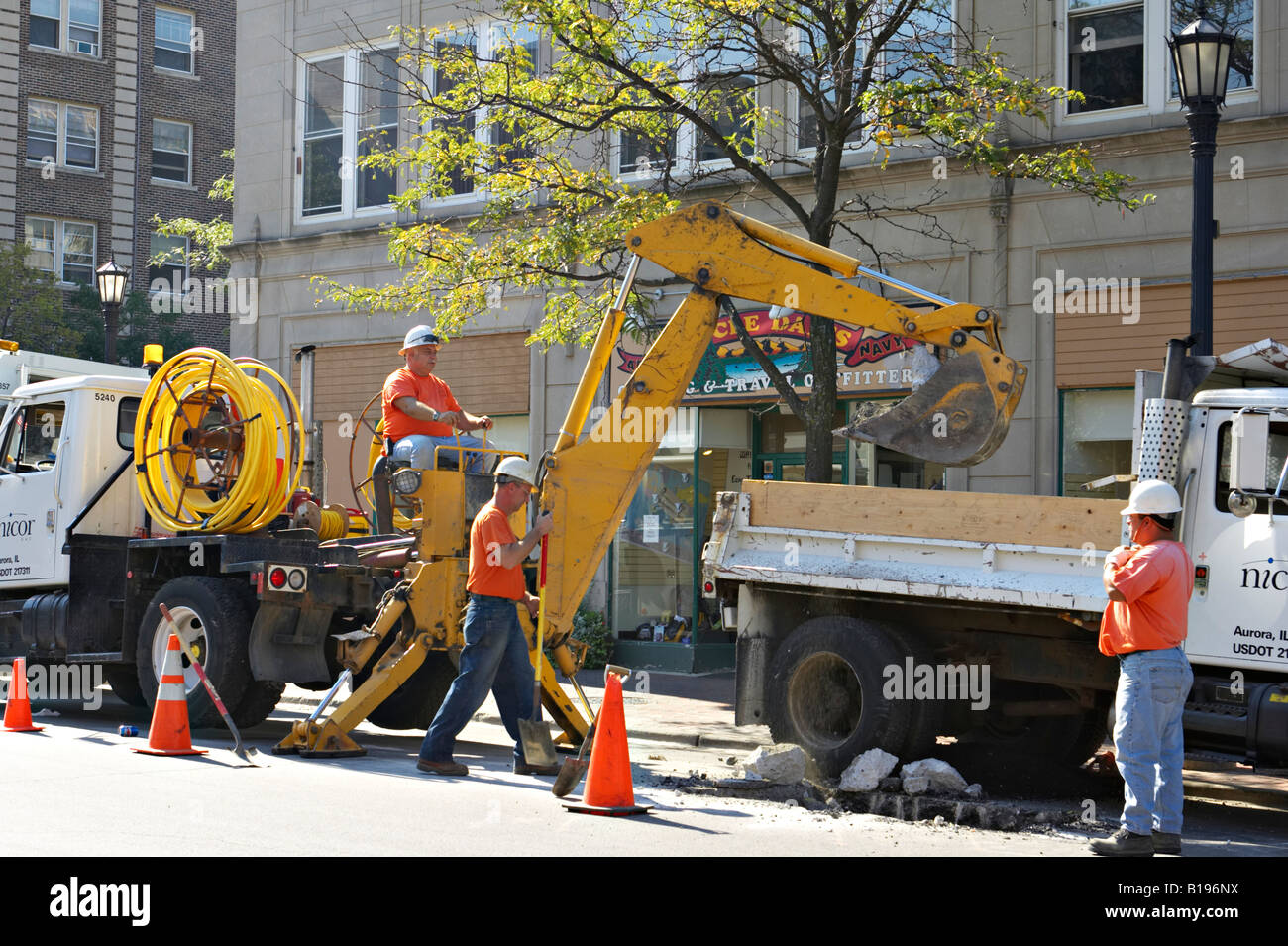 WORKERS Evanston Illinois Utility construction workers dig hole in ...