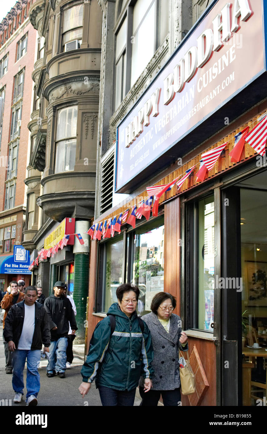 MASSACHUSETTS Boston People on sidewalk walk past restaurants and ...