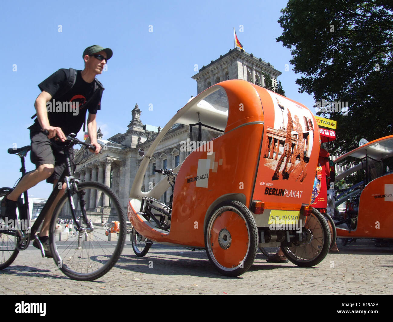 man riding bike by reichstag, berlin Stock Photo - Alamy