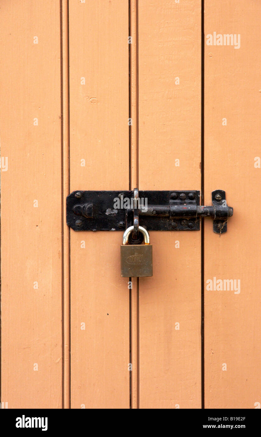 Pad lock securing a door Stock Photo - Alamy