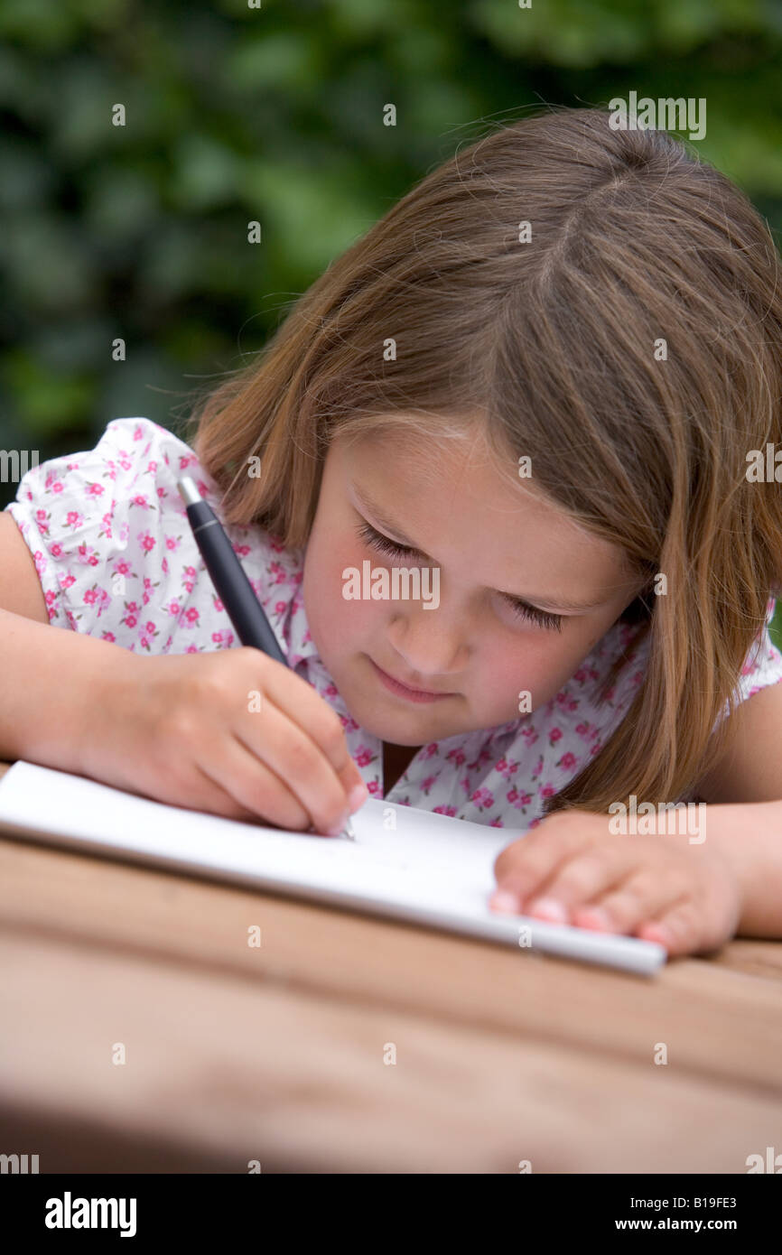 Little girl is writing Stock Photo - Alamy