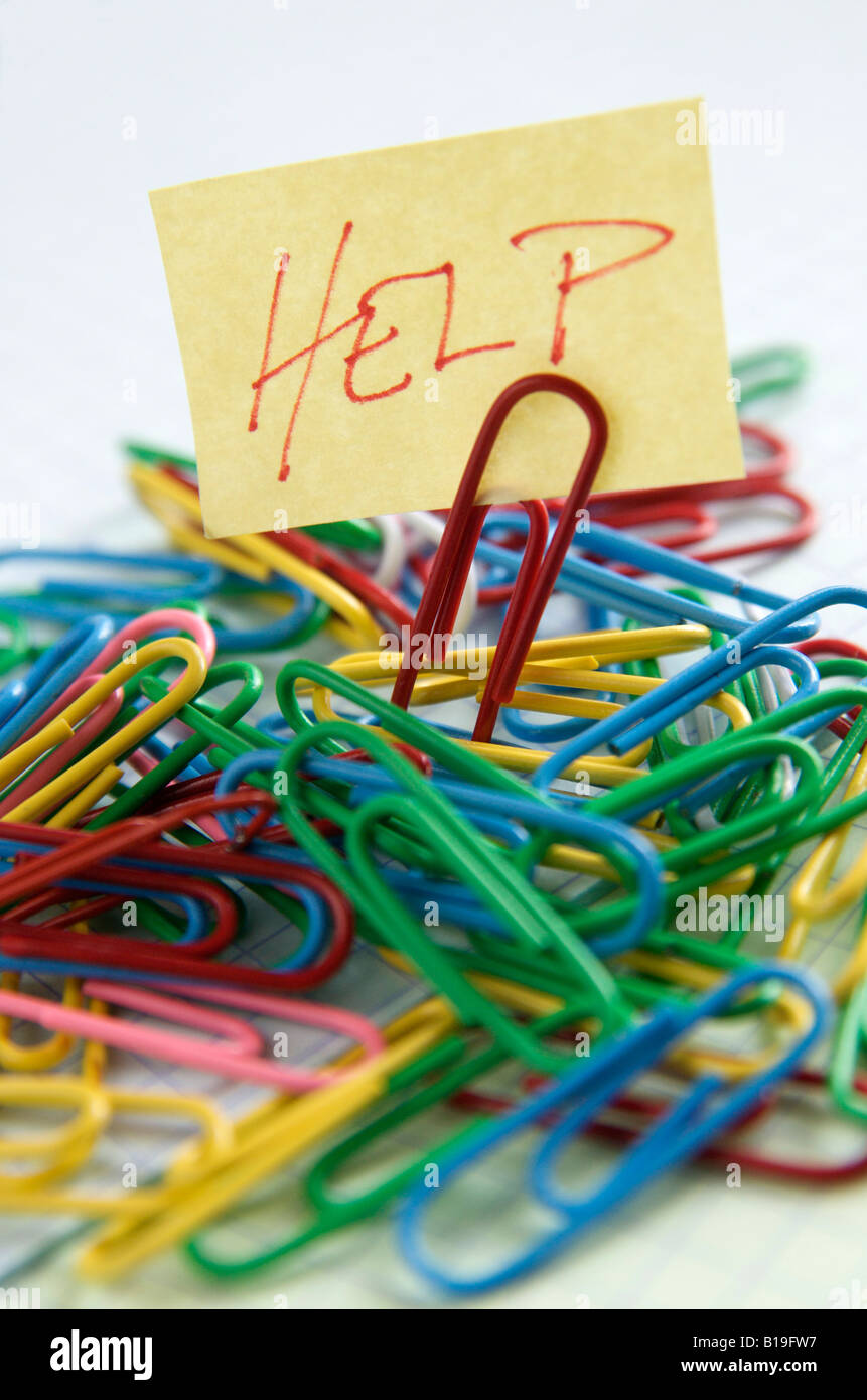 Paper clips and post-it note with Help written on it Stock Photo - Alamy