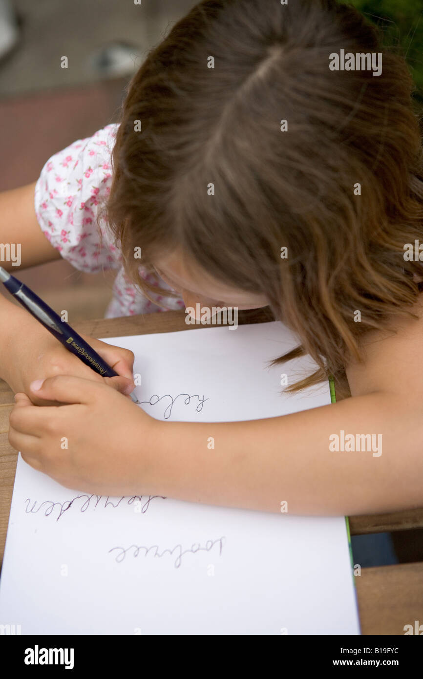 Little girl is hiding her writing Stock Photo - Alamy