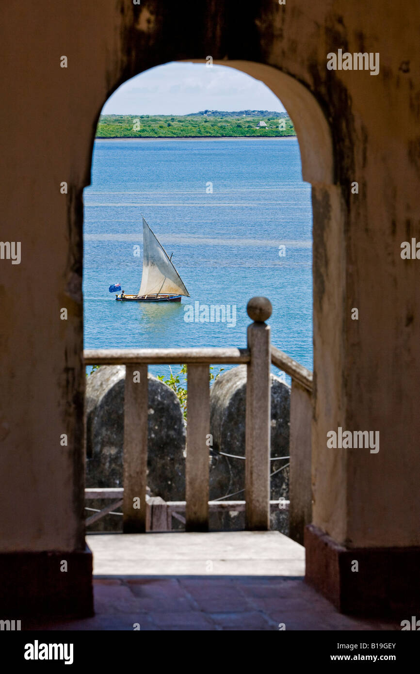 Kenya, Lamu Island, Lamu. A sailing boat (mashua) framed in an arch of ...