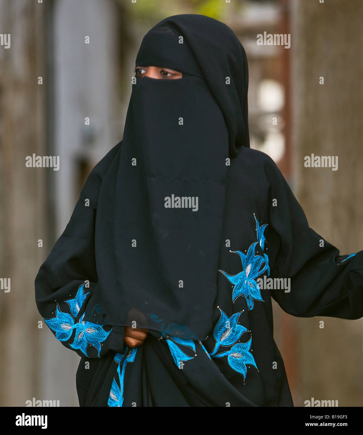 Kenya, Lamu Island, Lamu. A Muslim woman of Lamu town wearing a buibui ...