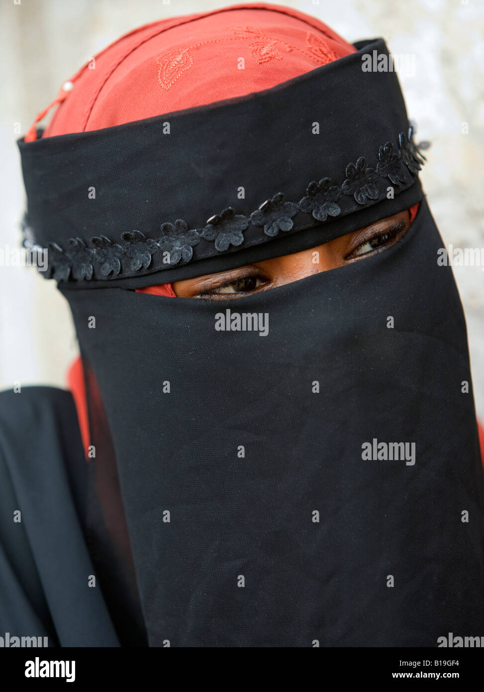 Kenya, Lamu Island, Lamu. A Muslim woman of Lamu town elegantly dressed ...