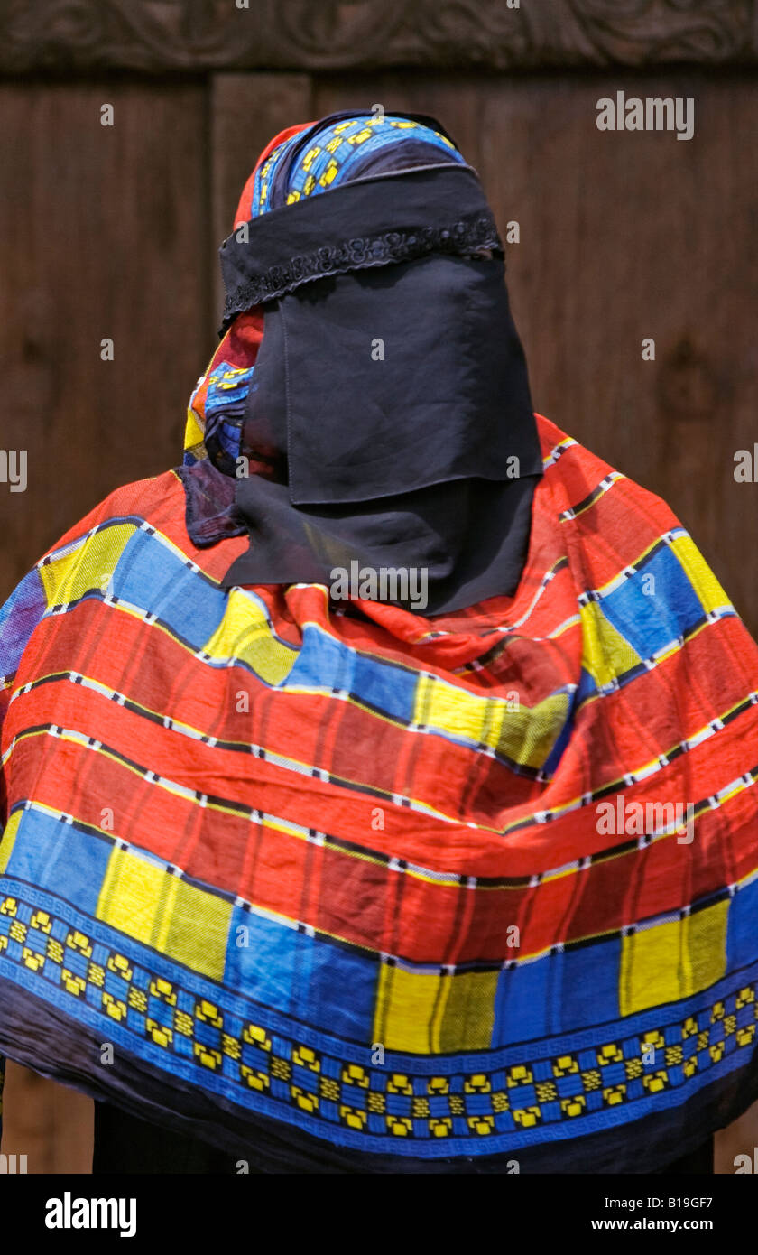Kenya, Lamu Island, Lamu. A Muslim woman of Lamu town wearing a buibui ...