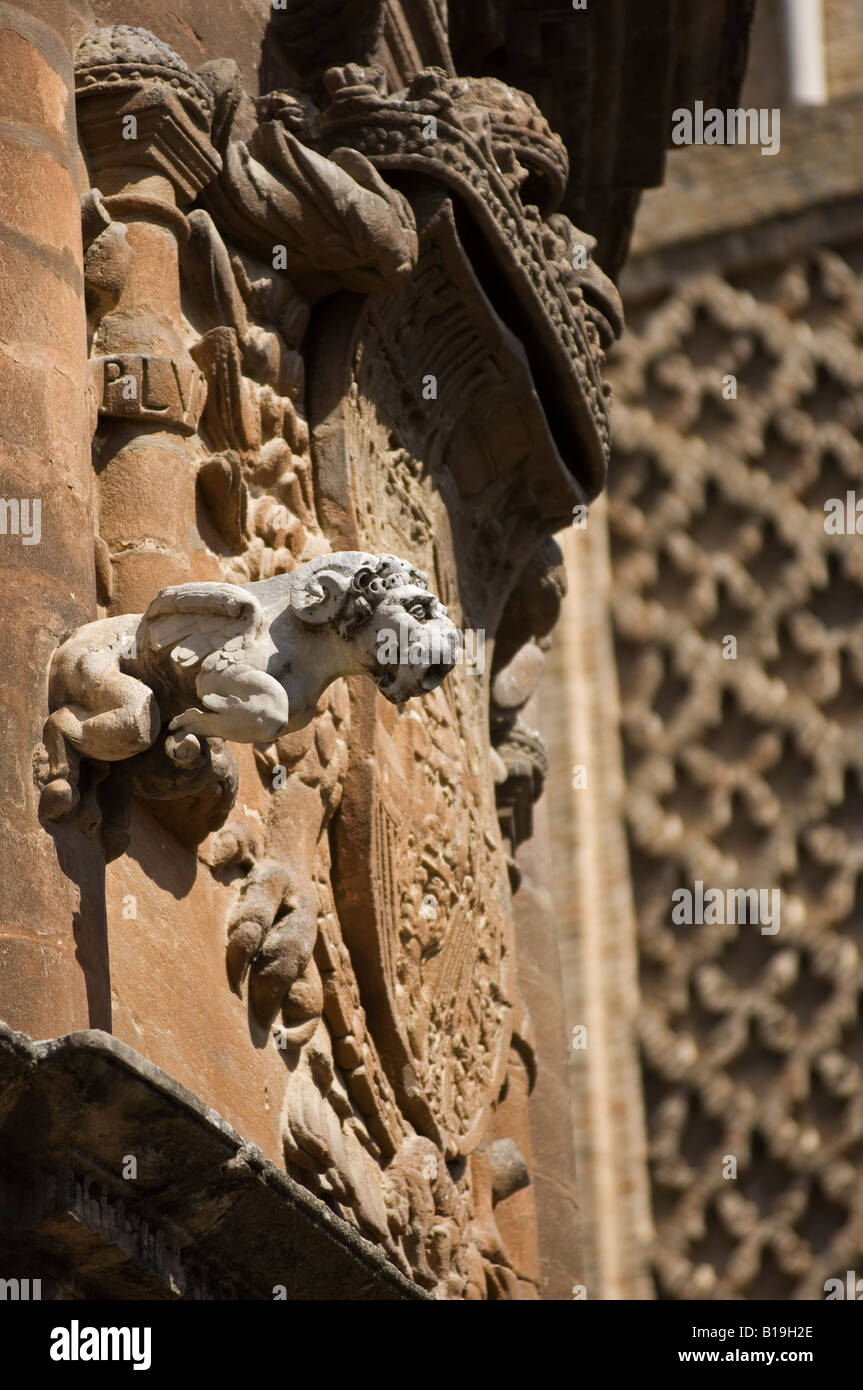 Spain, Andalucia, Seville. A gargoyle forms part of a coat of arms on ...