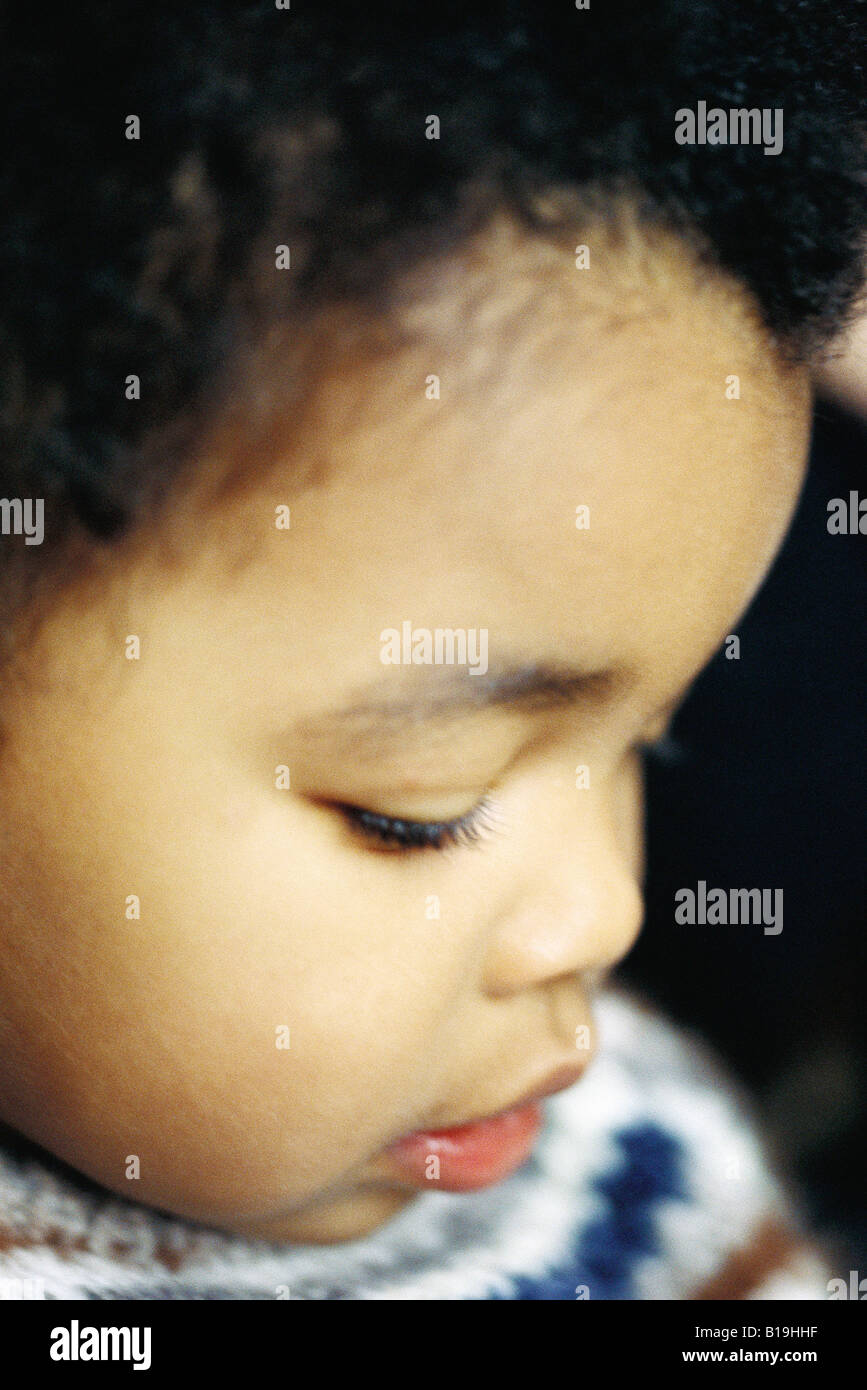 Child looking down, close-up of face, portrait Stock Photo - Alamy