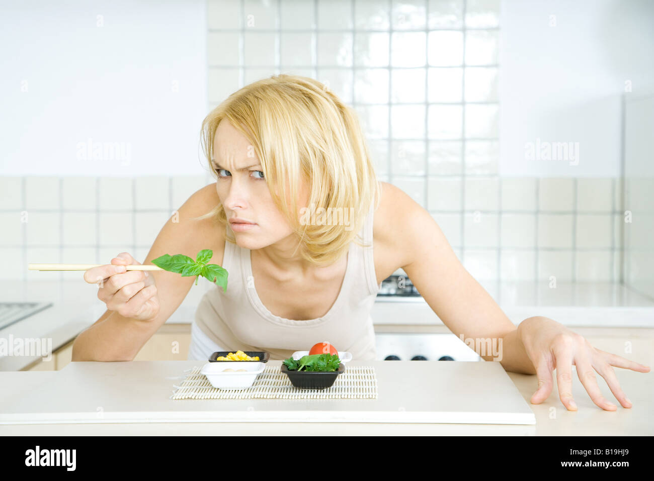 Woman leaning over food, looking at camera threateningly Stock Photo ...