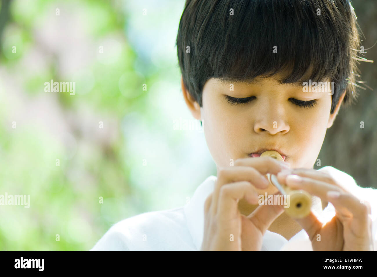 Boy playing recorder Stock Photo - Alamy