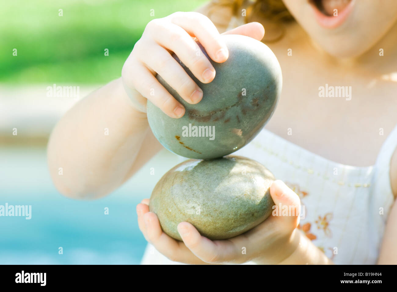 Child playing with stones Stock Photo - Alamy