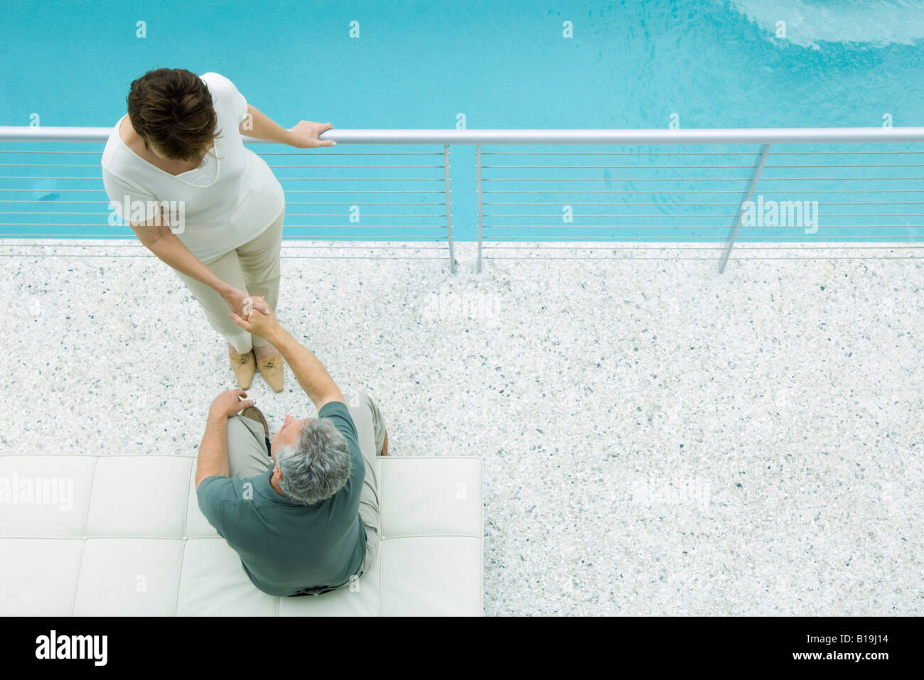 Couple on balcony, holding hands, high angle view Stock Photo - Alamy