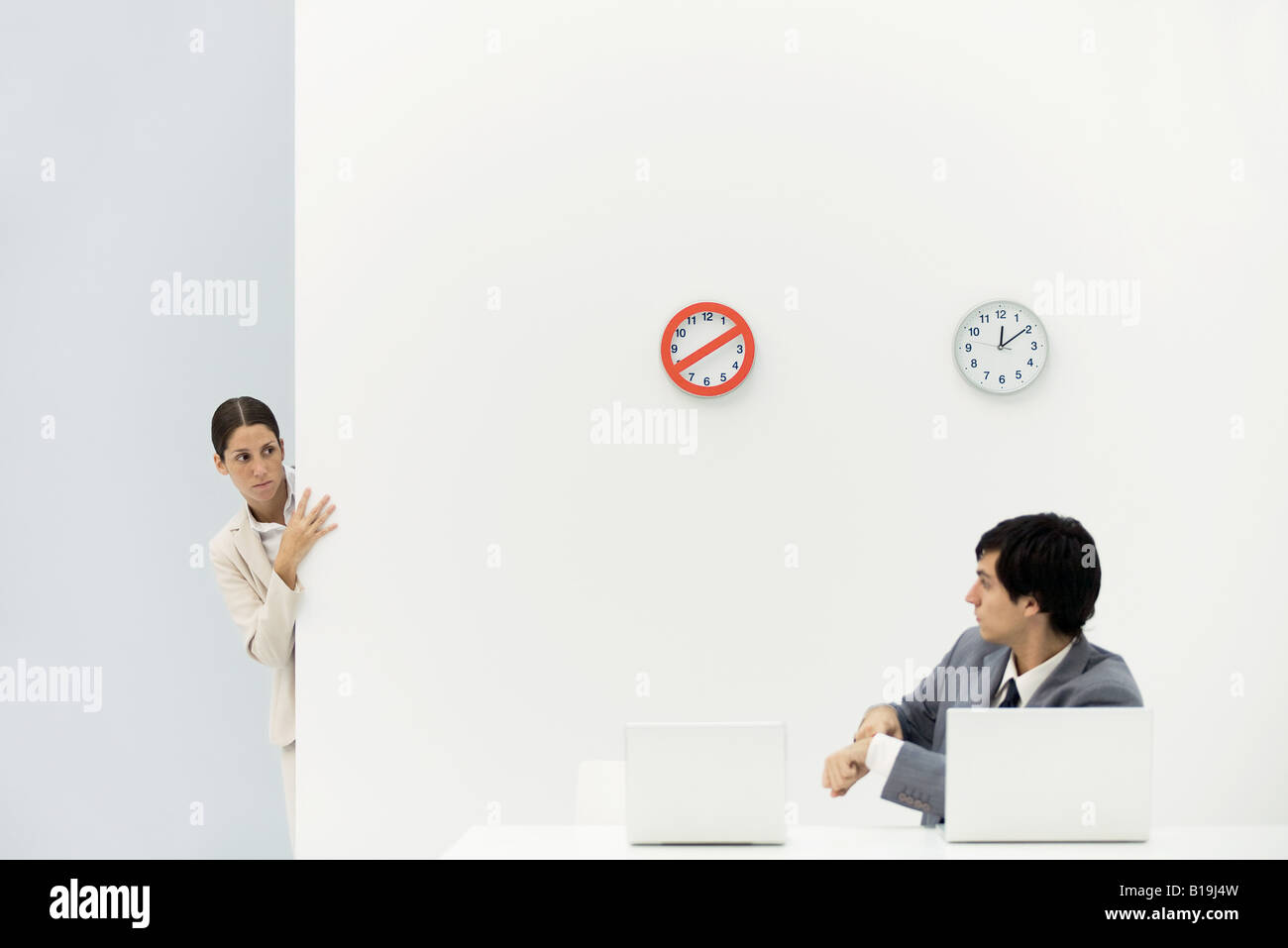Woman peeking around corner hi-res stock photography and images - Alamy