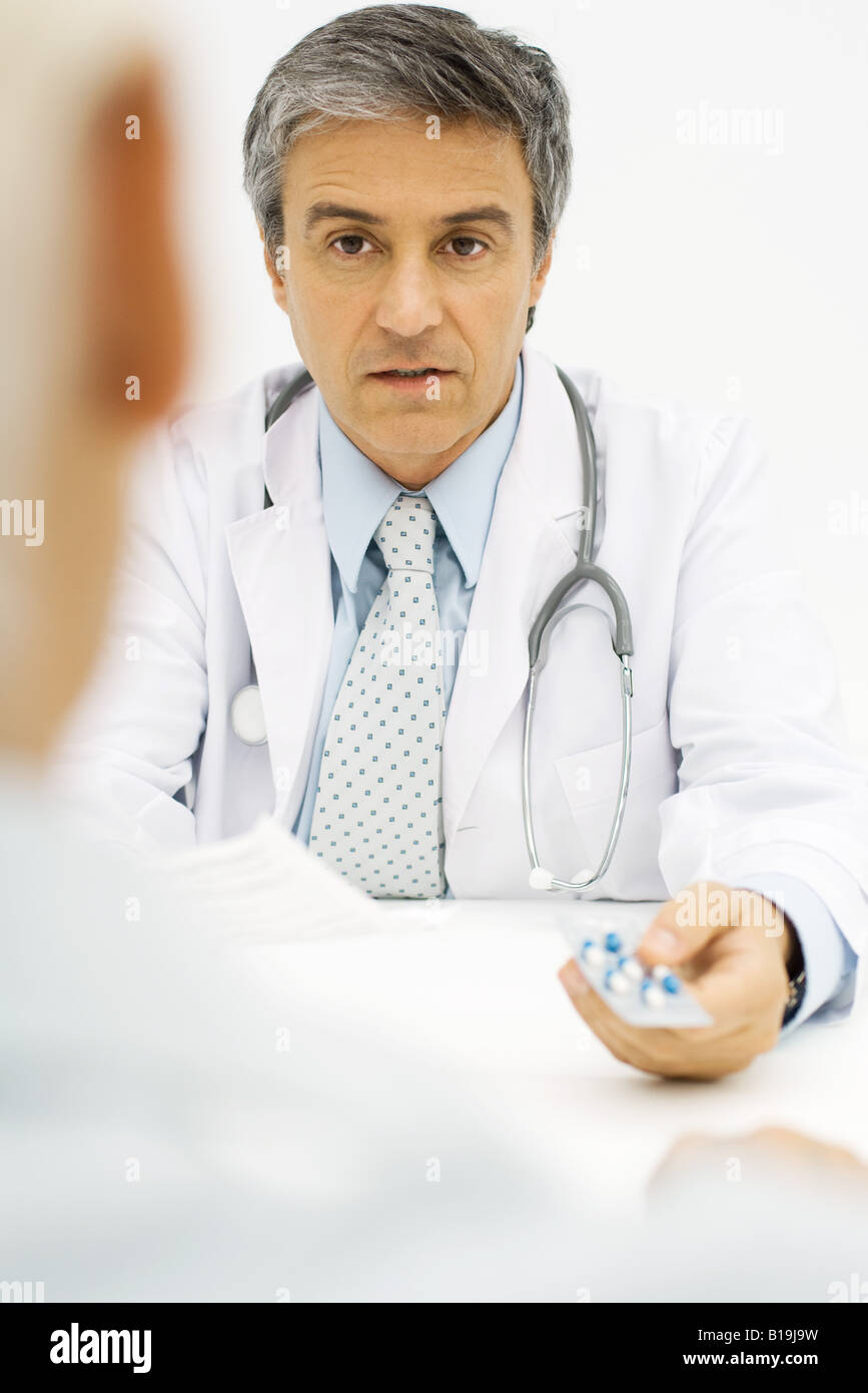 Doctor holds gives prescription patient hi-res stock photography and ...
