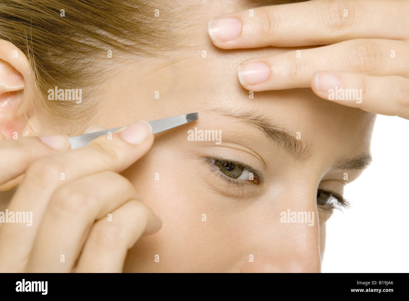 Woman tweezing her eyebrows, close-up Stock Photo - Alamy